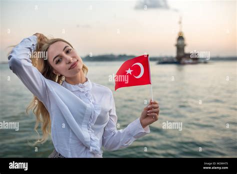 Attractive Young Beautiful Girl Waves Turkish Flag And Enjoys Sunset