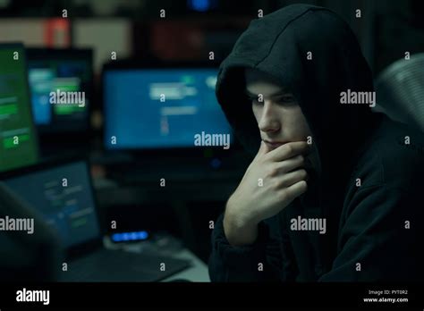 Cool Young Hacker With Hoodie Working With Computers Cybercrime And Data Security Concept Stock