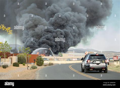 Many Firefighters Fighting A Fire Billowing Smoke In The Background In