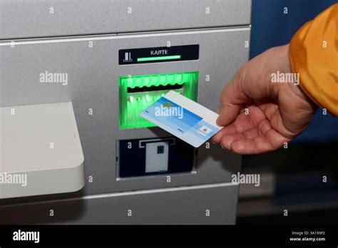 Woman Inserts Checking Card Into A Bank Statement Printer Stock Photo Alamy