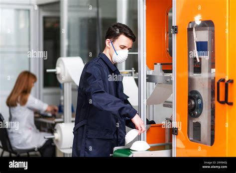 The Guy Works In A Factory For The Manufacture Of Medical Masks With