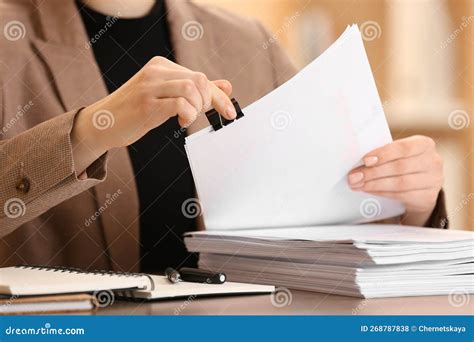 Woman Attaching Documents With Metal Binder Clip At Table In Office Closeup Stock Photo Image