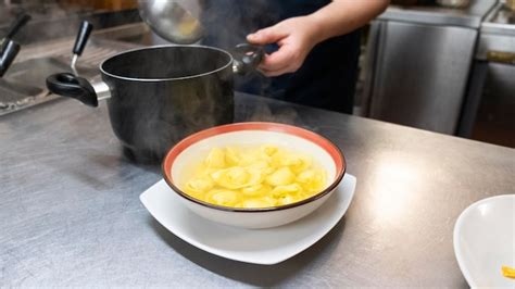 Premium Photo Preparation Of Cappelletti Plate Italian Cuisine Typical Dishes Of Emilia