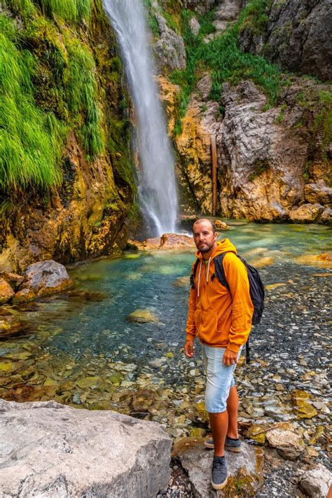 Premium Photo Hiker At Grunas Waterfall In Theth National Park