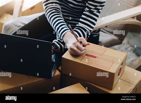 Online Selling Business Idea Beautiful Girl Writing Customer Address In Front Of Parcel