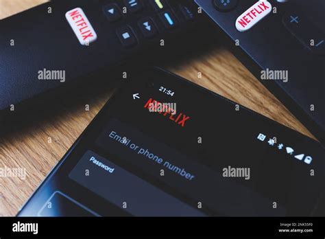 Netflix Login On Smartphone Display New Password Sharing Rules On Netflix Stock Photo Alamy