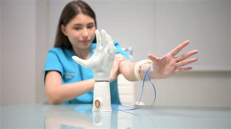 Technician Testing Robotic Bionic Arm At Prosthetic Manufacturing Stock