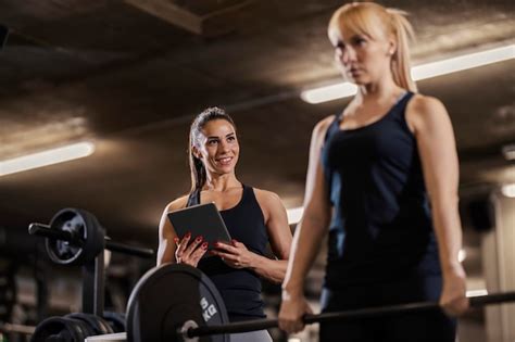 Premium Photo A Happy Coach Is Tracking Progress On A Tablet While