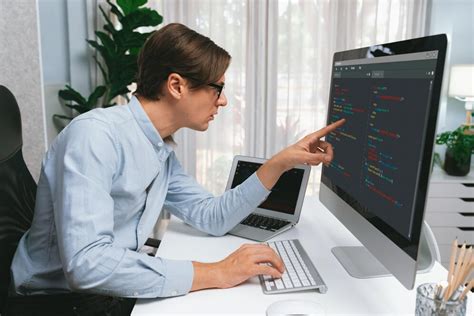 Premium Photo It Developer Pointing On Coding Software On Pc