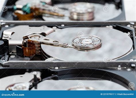 A Disassembled Open Hard Disk Drive HDD Of A Computer Or Laptop Lies On A Dark Matte Surface