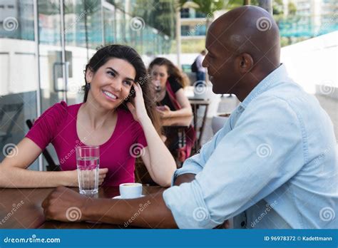 Caucasian Woman Flirting With African American Man At Restaurant Stock