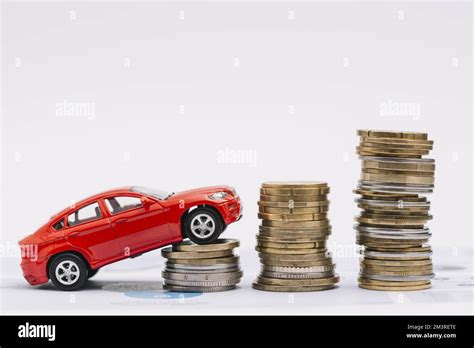 Toy Car Going Up Increasing Stack Coins Against White Background