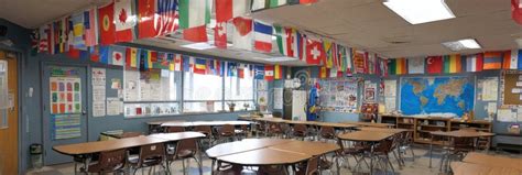 Multilingual Classroom Features Global Flags And Educational Posters In