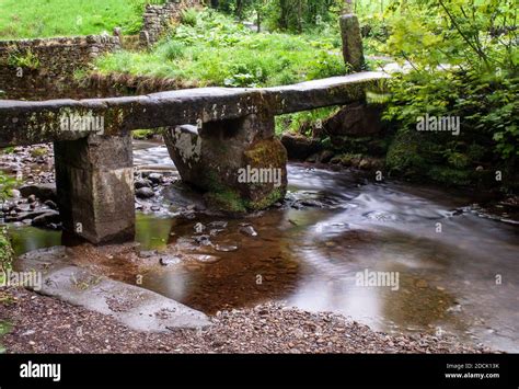 A Traditional Stone Clapper Bridge Crosses The Wycoller Beck Stream At