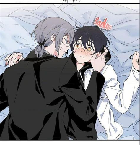 Two People Laying In Bed With Their Arms Around Each Other And One Person Holding His Head Up