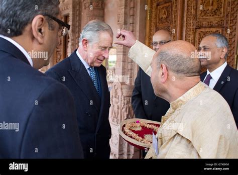 the prince of wales is anointed on the forehead and given a sandal wood garland before entering