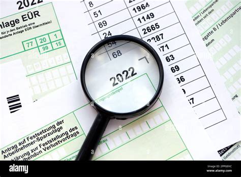 German Different Tax Forms And Magnifying Glass Pointed On 2022