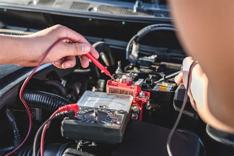 Premium Photo Man Checking The Battery Of A Car