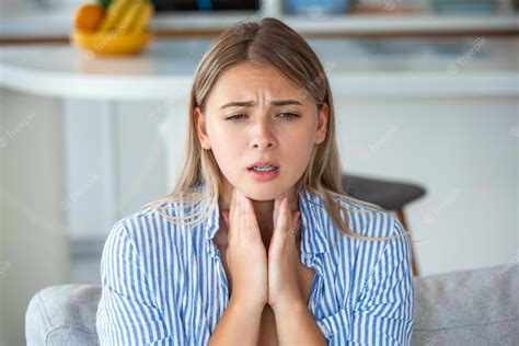 Premium Photo Close Up Of Young Woman Rubbing Her Inflamed Tonsils