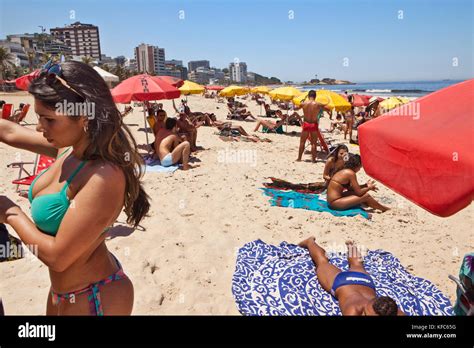 Brazil Rio De Janiero Several Beach Goers Hang Out In The Sand On
