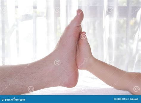 Feet Of Daddy And Boy Watching The Sea From The Beach Royalty Free Stock Photography
