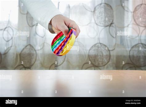 A Close Up Man Holding Stress Reliever Toy Manual Doll Toy Isolated On Curtain Background