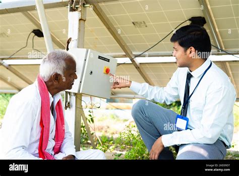 Engineer Explaining To Indian Farmer About Sloar Power Generation