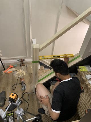 A Man Sitting On Top Of A Chair Next To A Pile Of Construction Equipment And Tools
