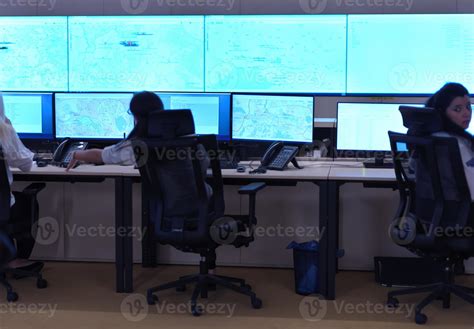 Female Security Guards Working In A Security Data System Control Room