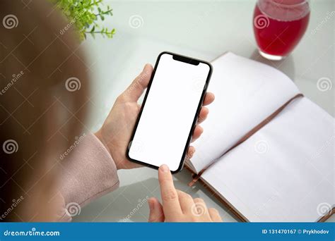 Woman Hands Holding Touch Phone With Isolated Screen Above The Table In The Office Stock Image