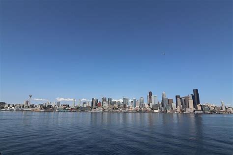 Premium Photo Sea And Buildings Of Seattle Skyline Against Clear Blue Sky