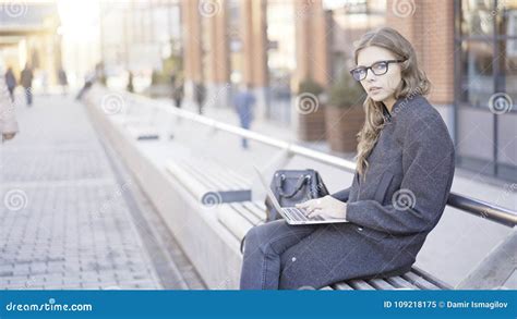 Young Businesswoman Typing Outside And Looking At You Stock Image