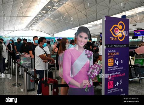 Passengers Wearing Masks Line Up At The Check In Counter For Bangkok In