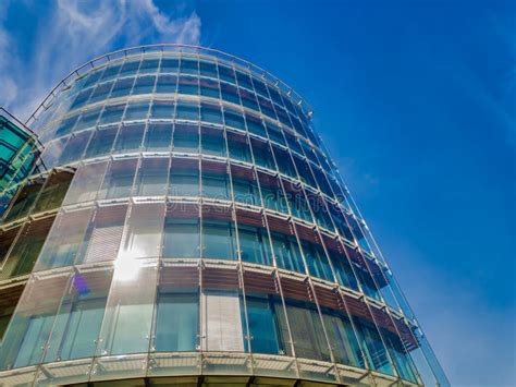 Modern Round Building With Reflected Sky And Cloud In Glass Window With