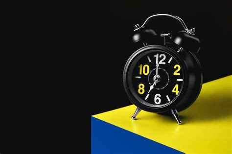 Premium Photo The Hands Of The Alarm Clock Indicate Seven O39clock A Black Alarm Clock Stands