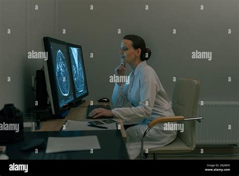 Female Doctor Neuroscientist Analyzing Brain Scan Mri Images In