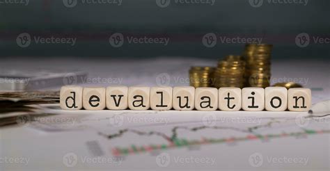 Word Devaluation Composed Of Wooden Letter Stacks Of Coins In The