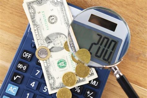 Premium Photo Fraud Concept With Magnifier And Calculator On Wooden