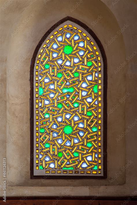 Perforated Stucco Window Decorated With Colorful Stain Glass With