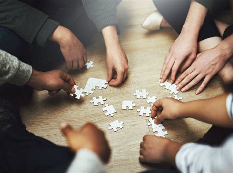 People Teamwork And Hands With Puzzle On Floor For Problem Solving Support And Integration Of