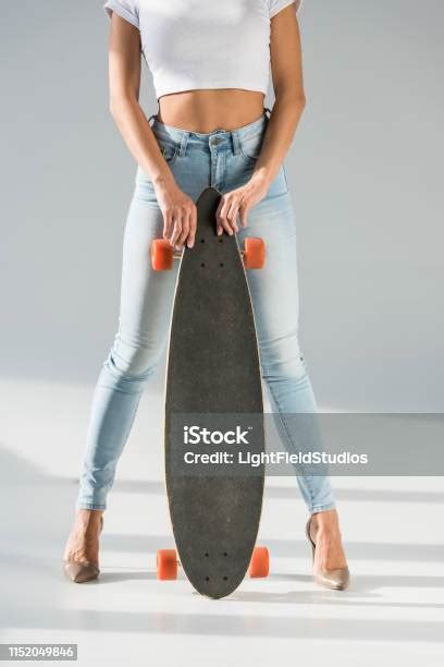 청바지와 하이 힐 여자의 부분 보기 회색 배경에 서 있는 롱 보드 백인종에 대한 스톡 사진 및 기타 이미지 백인종 부분의 사람들 Istock