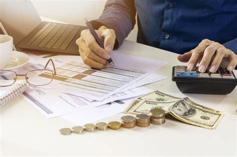 Business People Calculate Financial Numbers Investment Finance The Financial Cost Of Doing