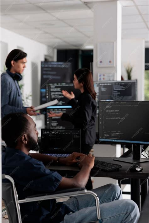 Premium Photo It Programmer In Wheelchair Typing Html Code In Coding Office Working On Server