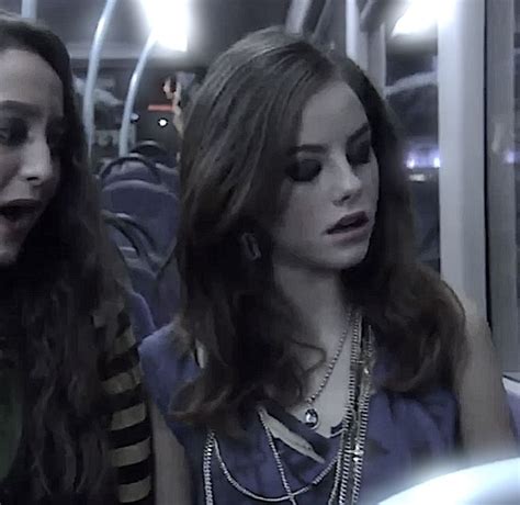 Two Young Women Sitting On A Bus Looking At Something In The Distance