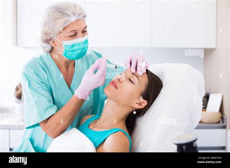 Young Woman Getting Injection For Facial Correction Procedure In