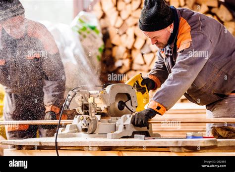 Carpenter Working Man Cutting Plank By Circular Saw Stock Photo Alamy