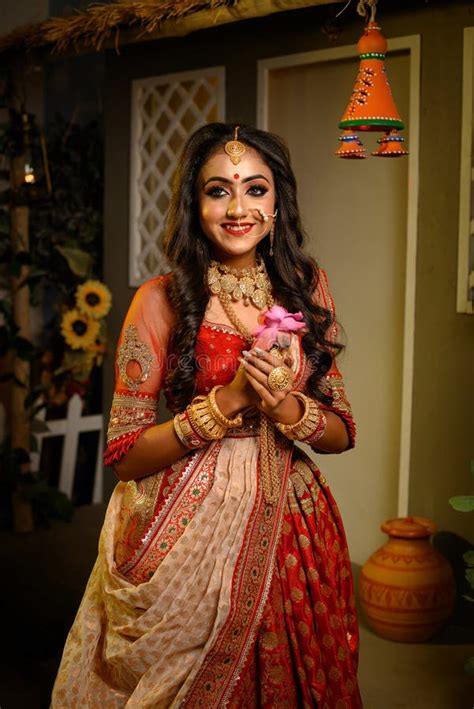 Portrait Of Pretty Young Indian Girl Wearing Traditional Saree Gold Jewellery And Bangles