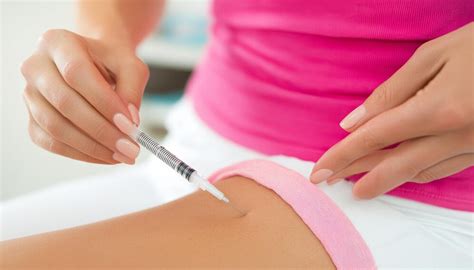 Closeup Of A Young Woman Selfadministering An Injection Into Her Thigh