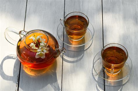 유리 주전자에 재스민을 꽃 나무 흰색 배경에 컵에 차 단단한 그림자와 자연 채광 사진 녹색 재스민 차와 컵 0명에 대한 스톡 사진 및 기타 이미지 Istock