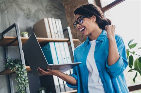 Photo Of Attractive Young Woman Hold Netbook Winning Wear Blue Shirt Modern Office Programmer